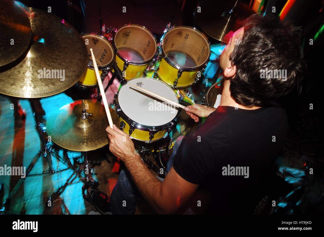 Drummer performing on stage at concert Stock Photo - Alamy