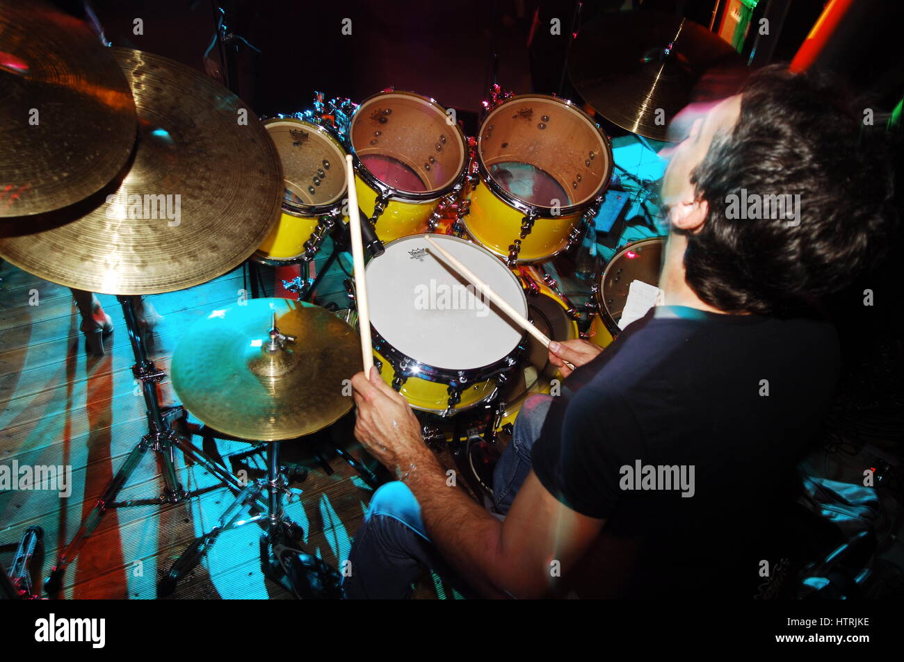 Drummer performing on stage at concert Stock Photo - Alamy
