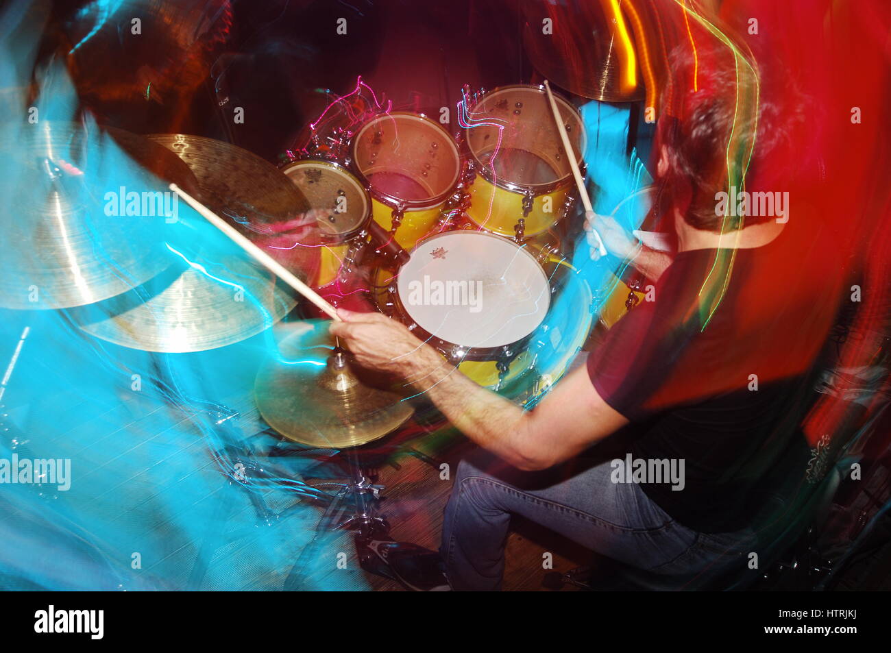Drummer performing on stage at concert Stock Photo - Alamy
