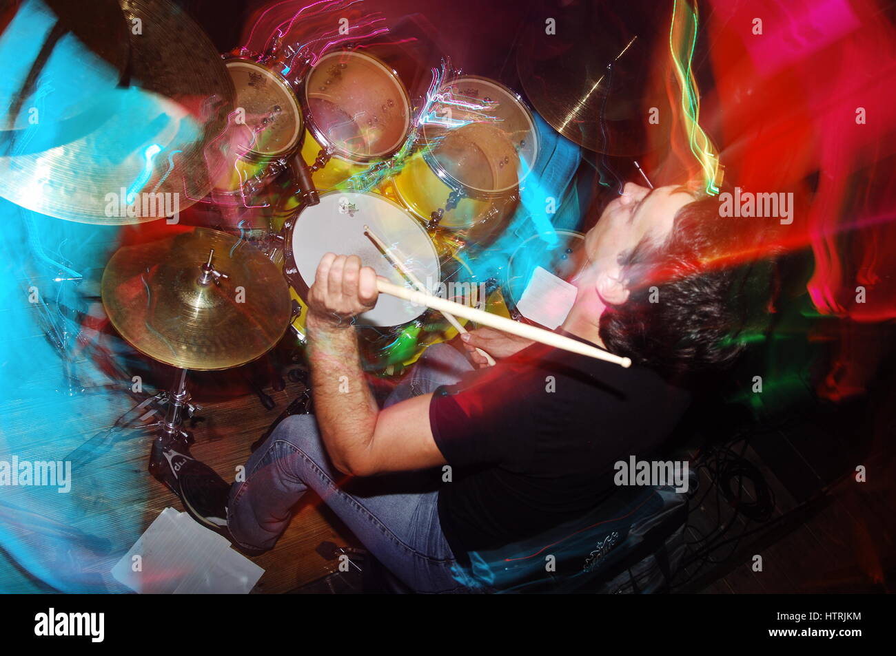 Drummer performing on stage at concert Stock Photo - Alamy