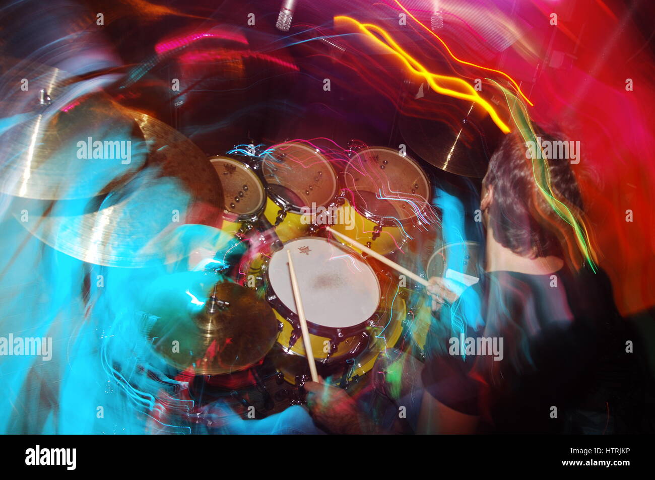 Drummer performing on stage at concert Stock Photo - Alamy