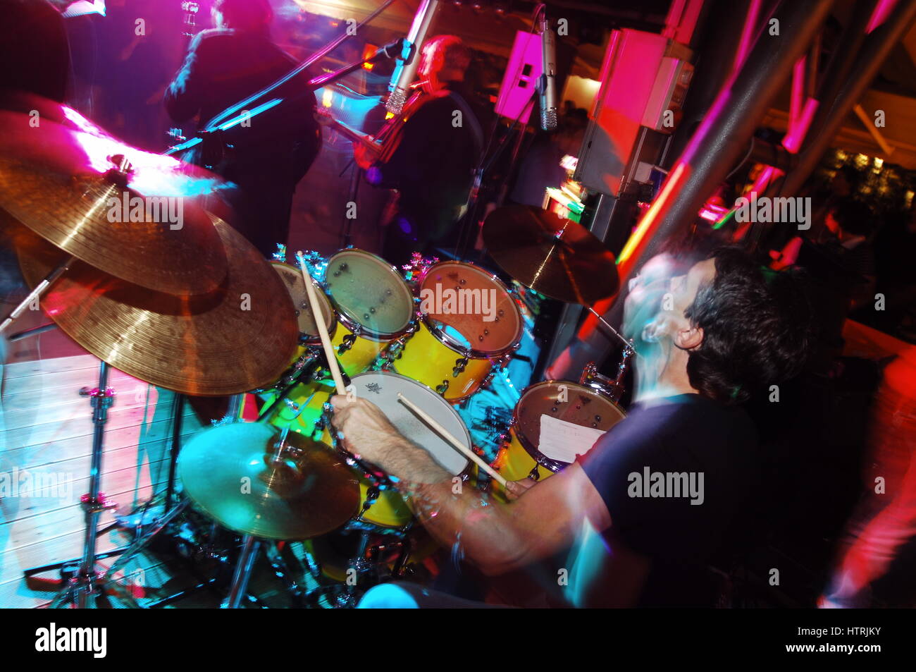 Drummer performing on stage at concert Stock Photo - Alamy