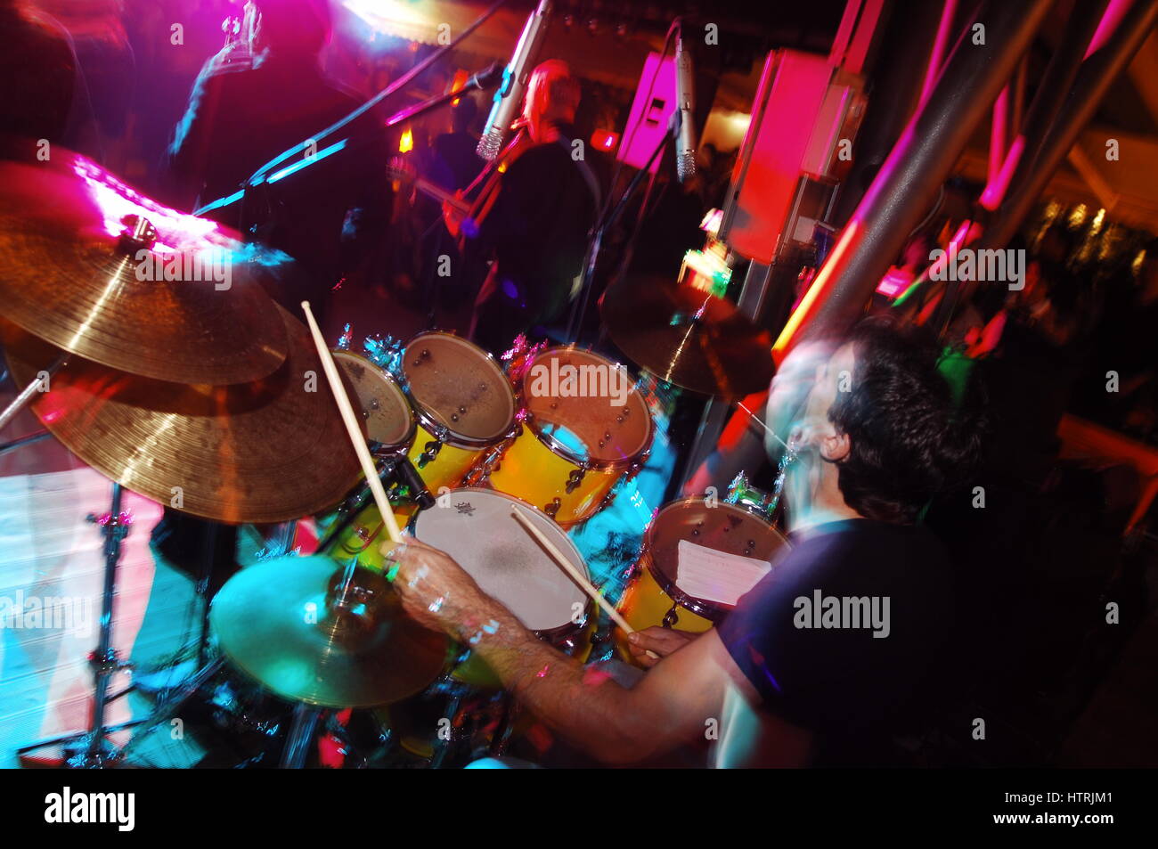 Drummer performing on stage at concert Stock Photo - Alamy