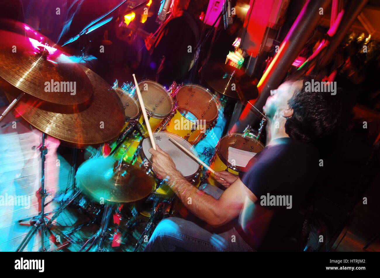 Drummer performing on stage at concert Stock Photo - Alamy