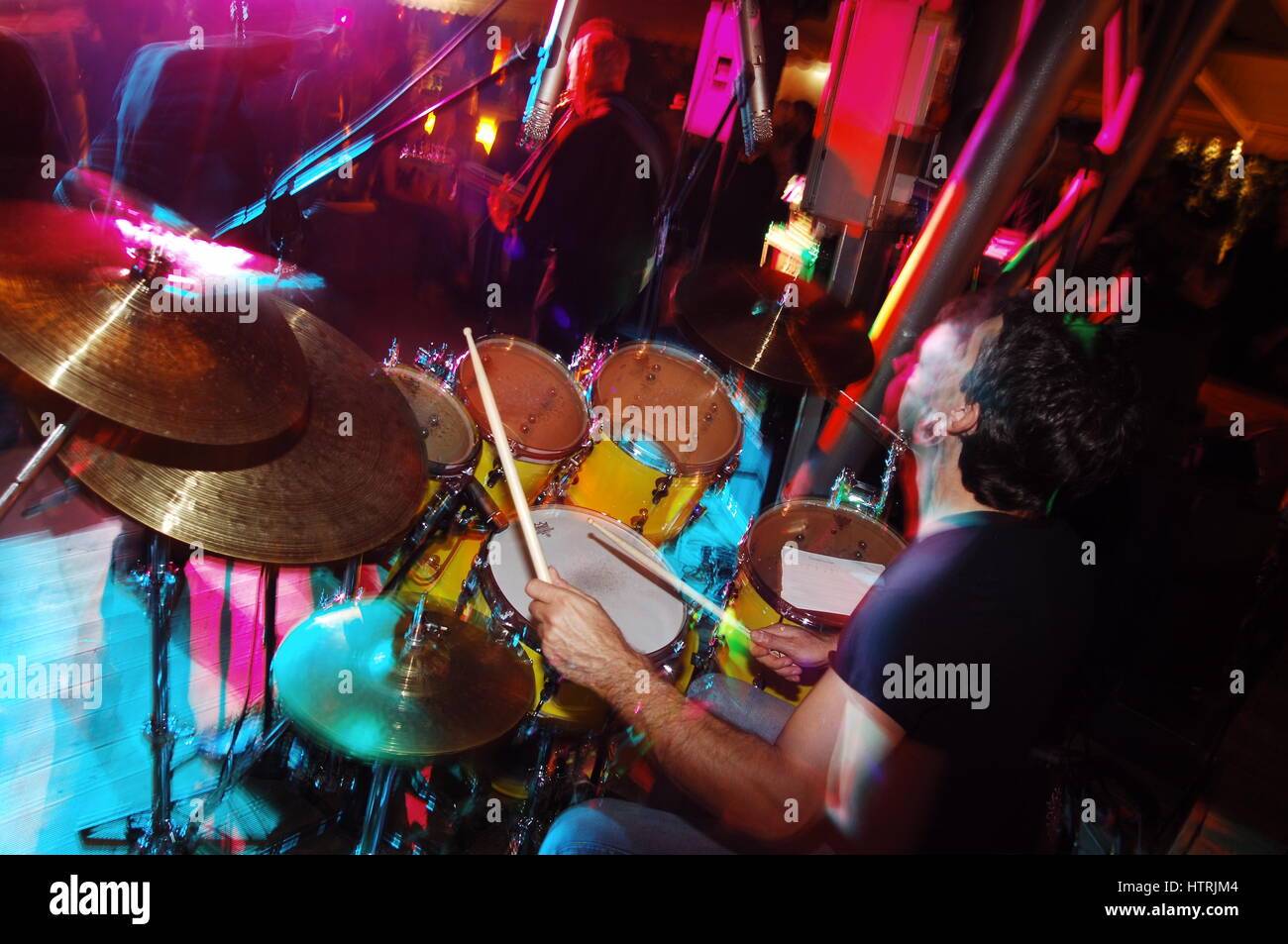 Drummer performing on stage at concert Stock Photo - Alamy