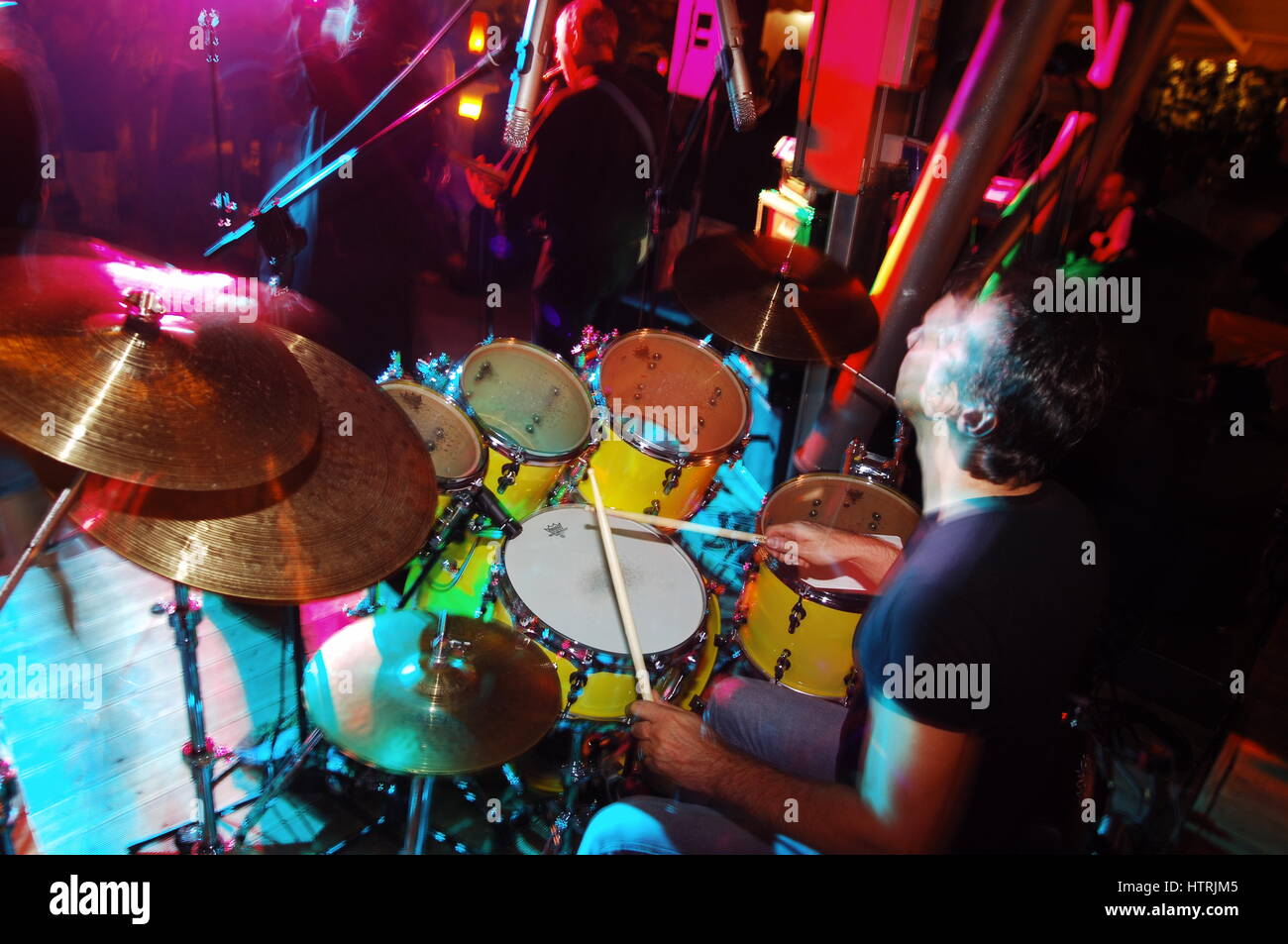 Drummer performing on stage at concert Stock Photo - Alamy
