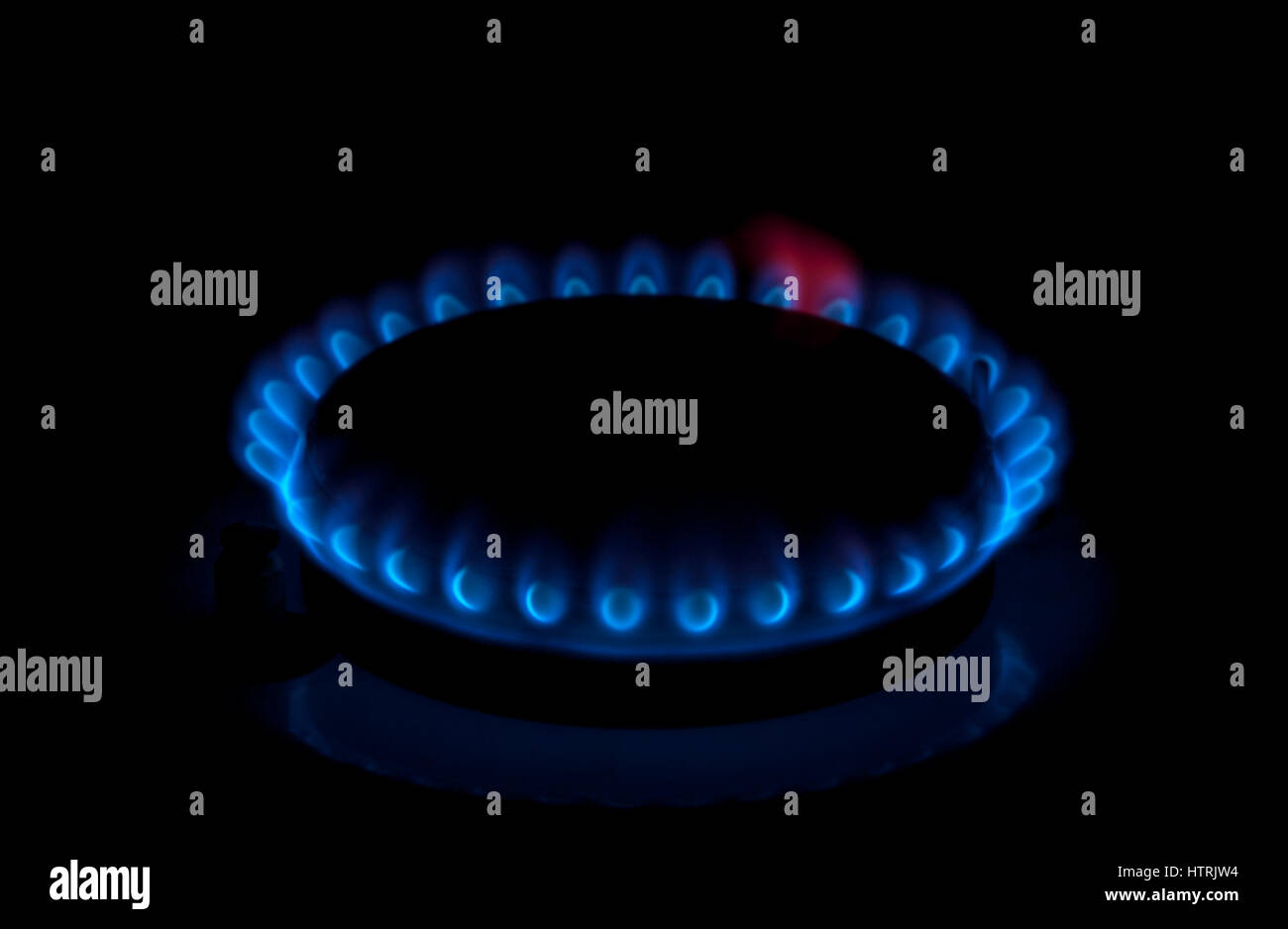 Natural gas burning a blue flames on black background Stock Photo - Alamy