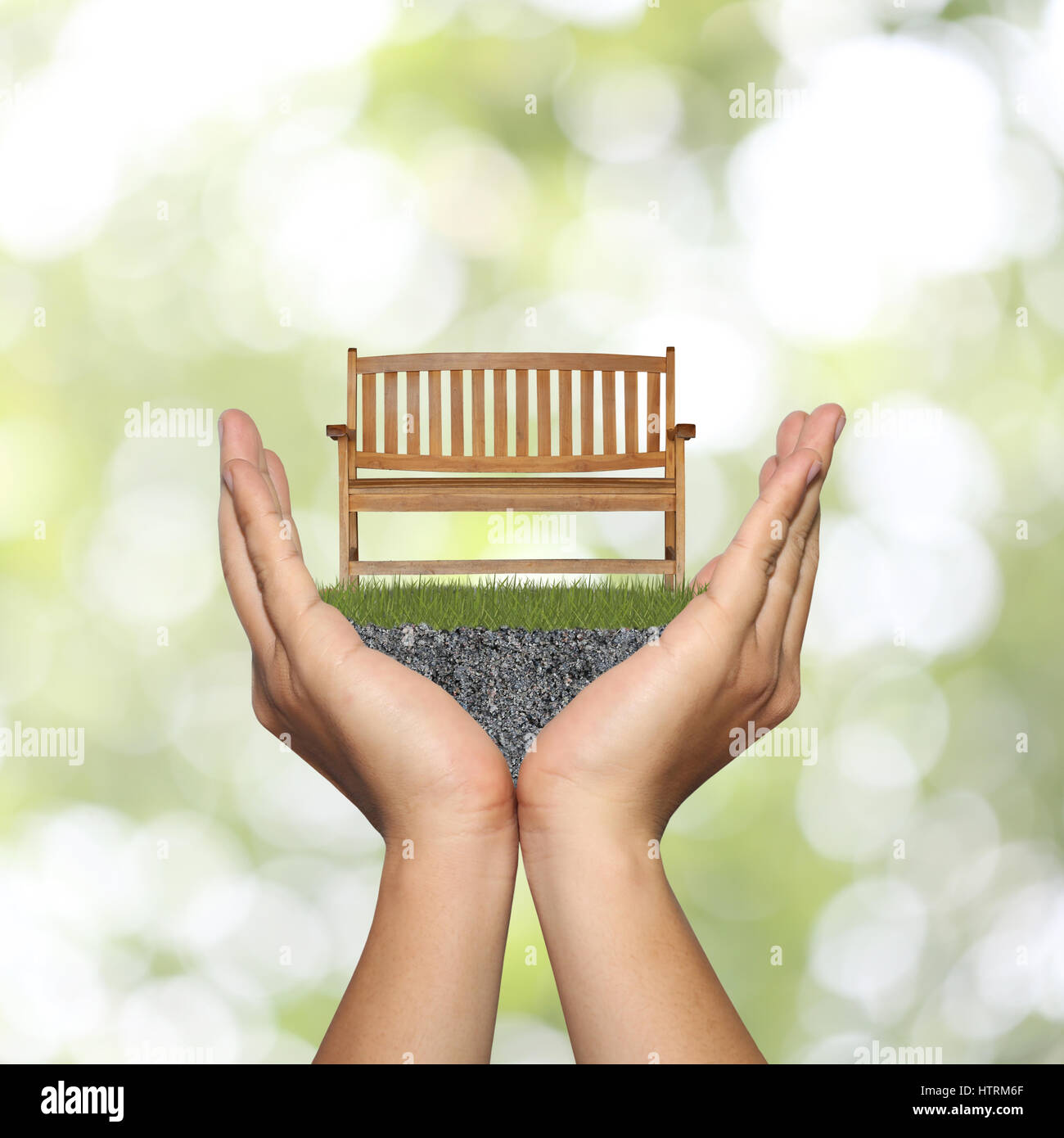 hand of man and green lawn with wooden bench in concept of emptiness ...
