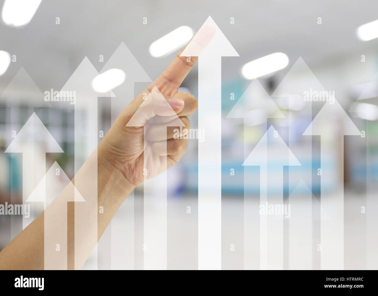 Hand of business man point to the highest point of the arrow in concept ...