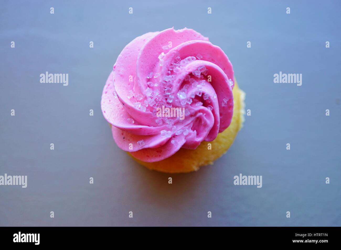 Mini cupcake with pink frosting and sanding sugar on top Stock Photo ...