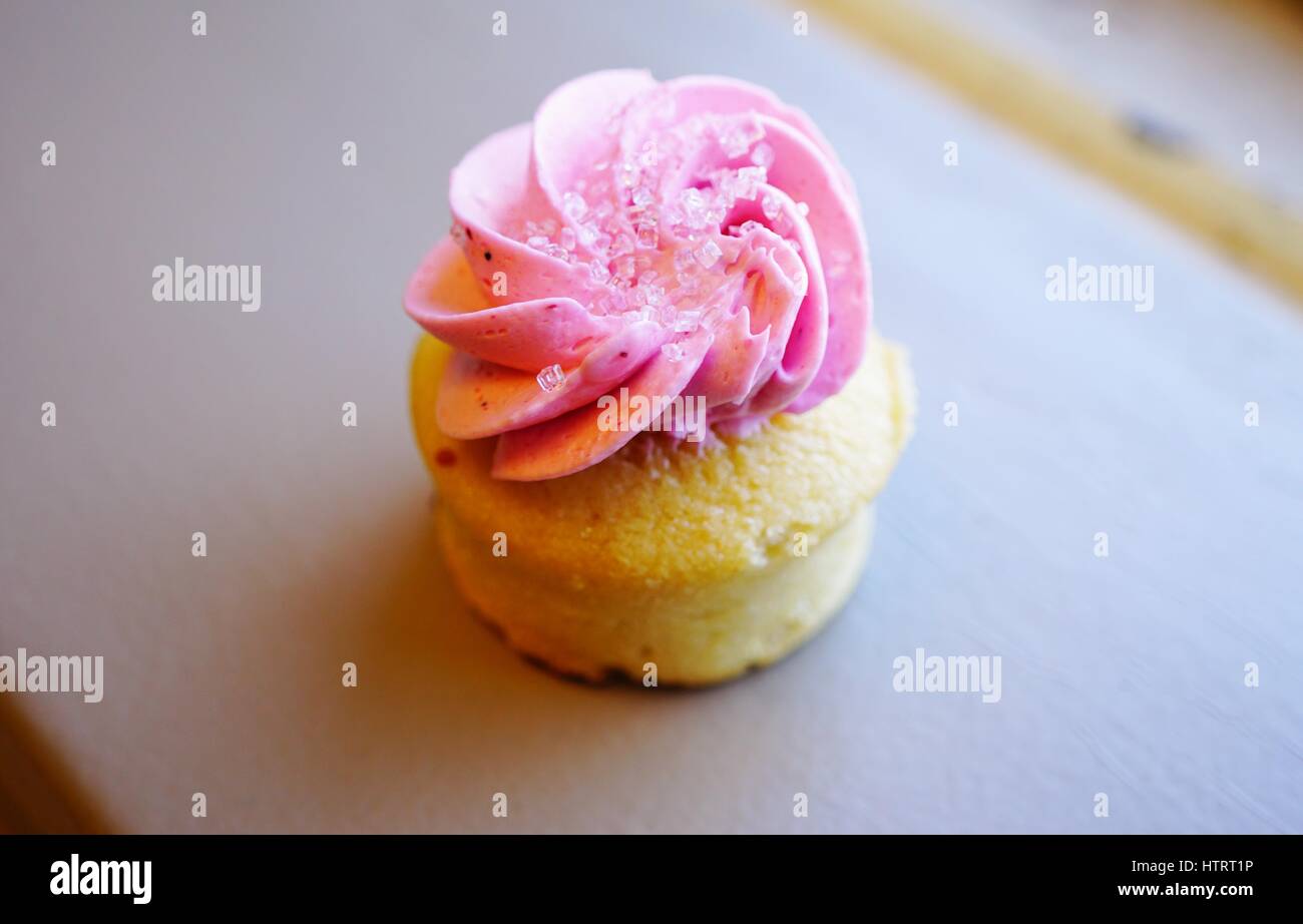 Mini cupcake with pink frosting and sanding sugar on top Stock Photo ...