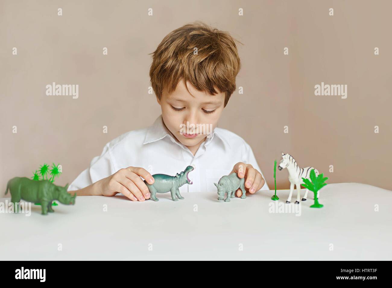 a little child plays with toys animals Stock Photo - Alamy