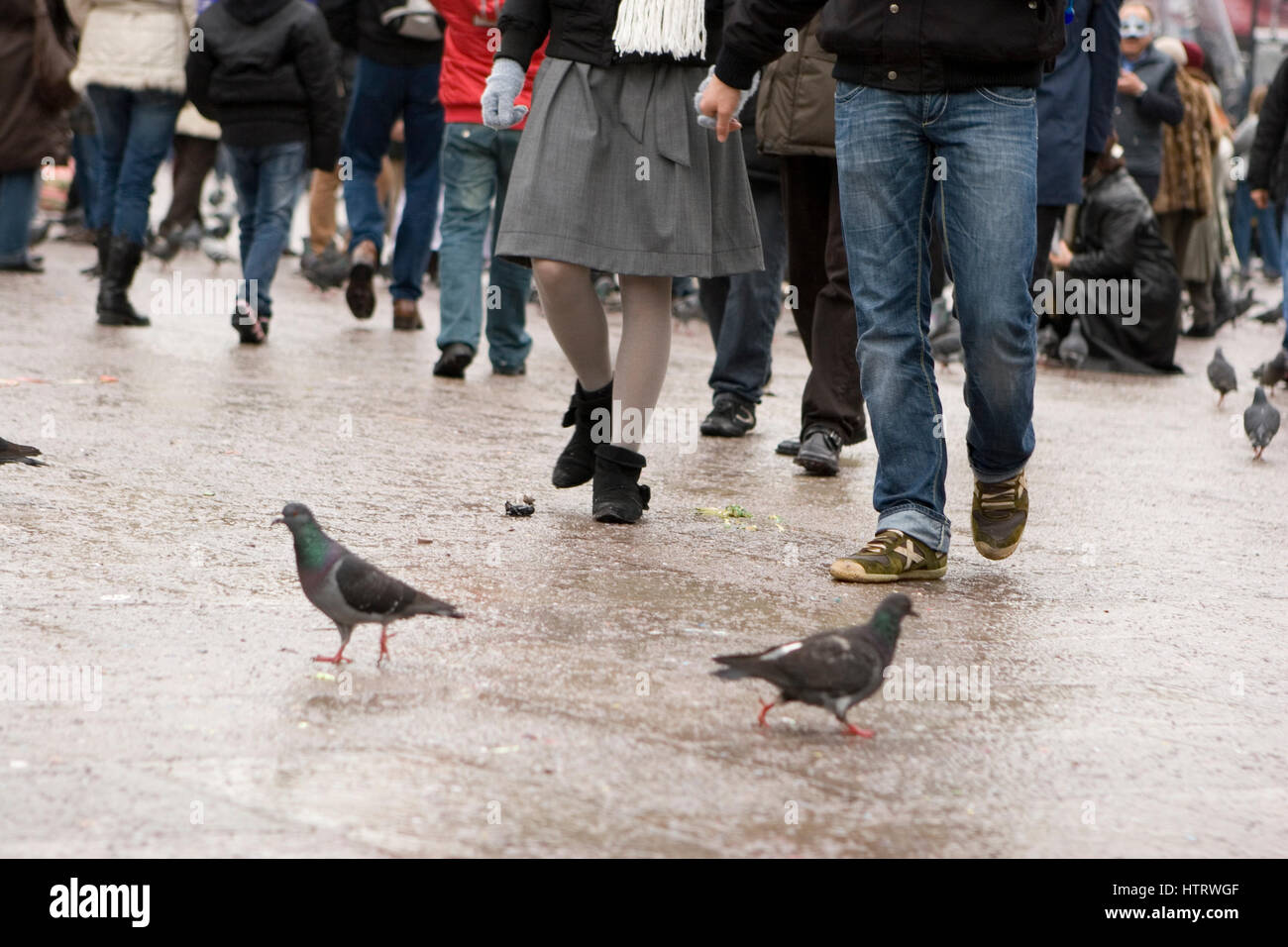 A crowd of people walking around outside Stock Photo - Alamy