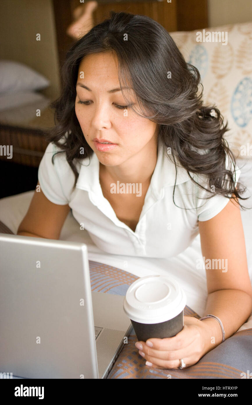Asian student laptop bed vertical hi-res stock photography and images ...
