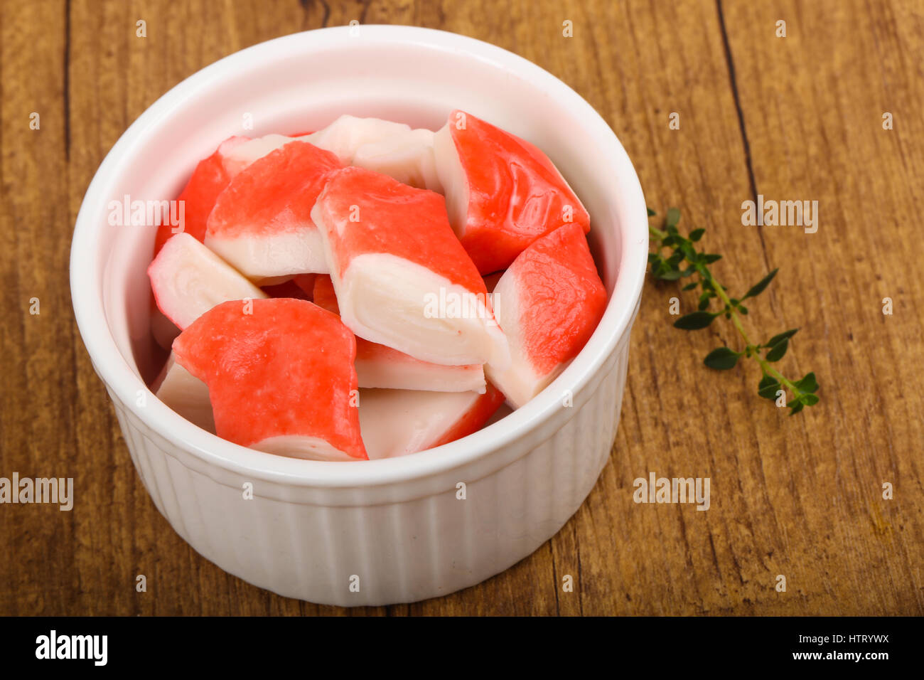 Crab stick - surimi in the plate - over wood background Stock Photo - Alamy