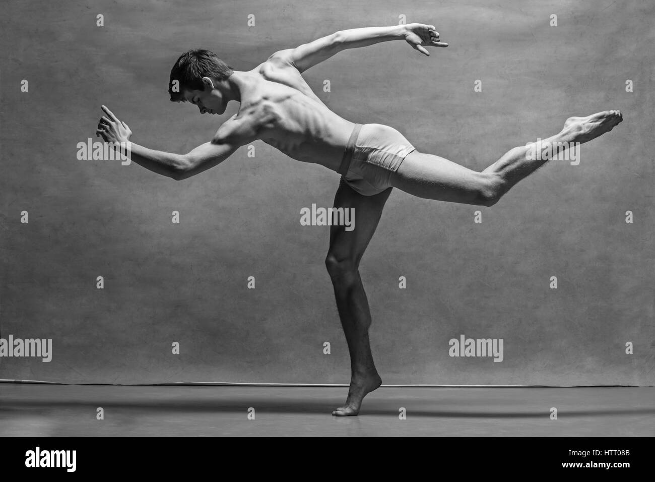 The male ballet dancer posing over gray background Stock Photo - Alamy
