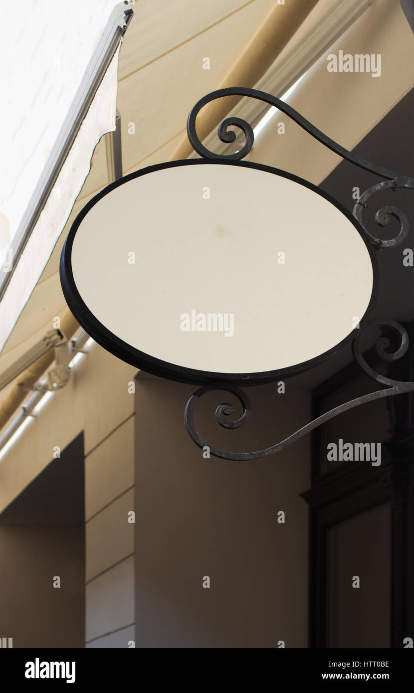 Vertical front view of empty round signage on a building with classical ...