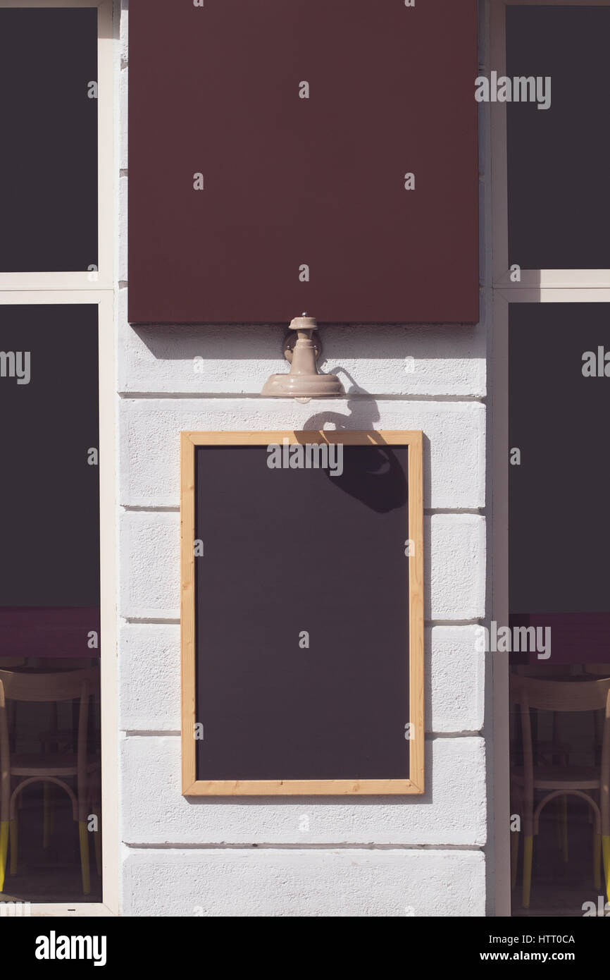 vertical front view of black empty chalkboard menu frame on restaurant ...