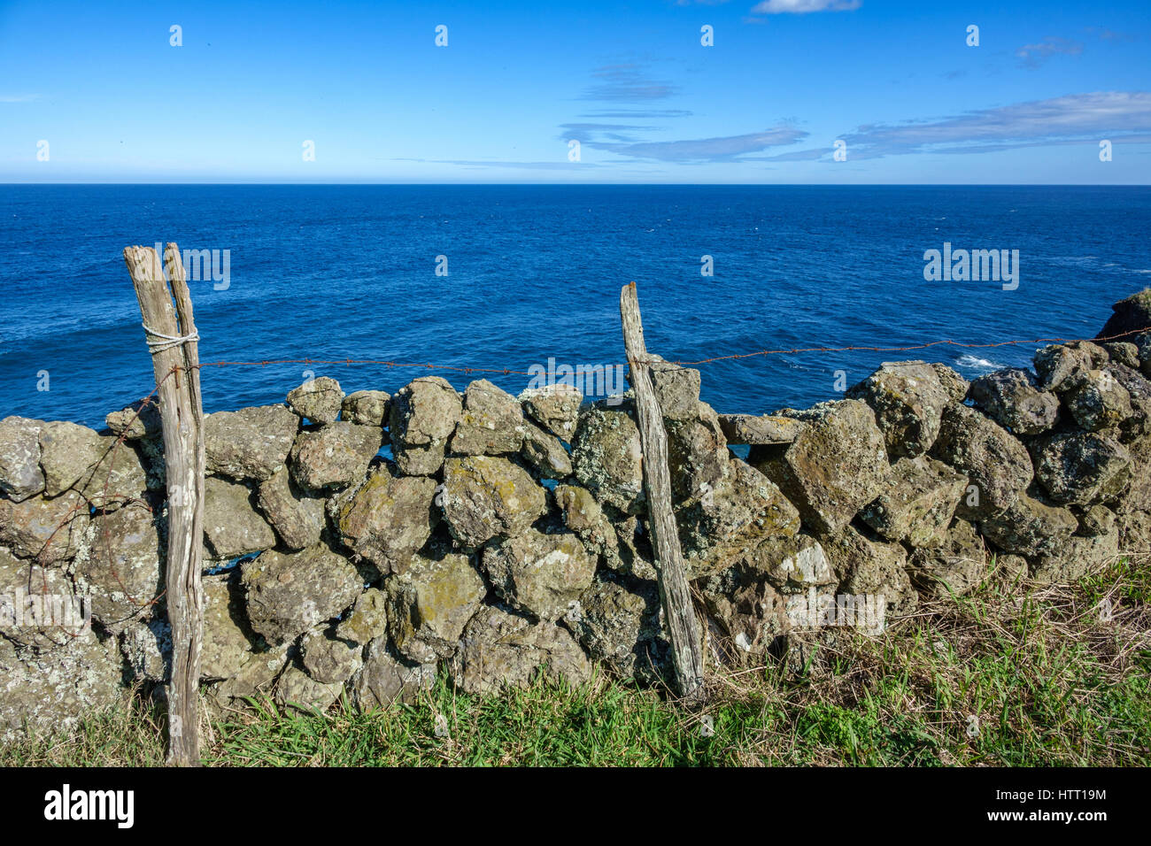 Stone volcanic wall near ocean Stock Photo - Alamy