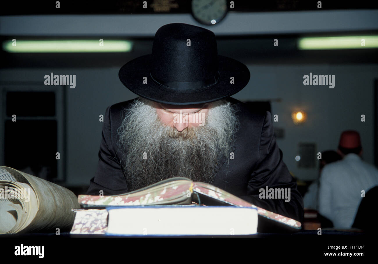 Rabbi lighting menorah Hanukah Stamford Hill North London Stock Photo ...