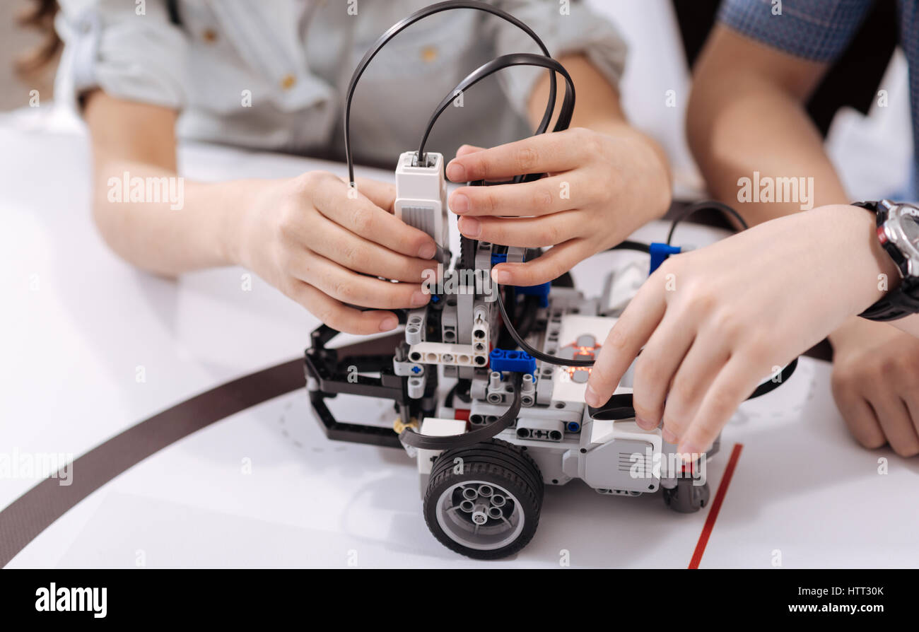 Young pupils creating electronic robot at school Stock Photo - Alamy