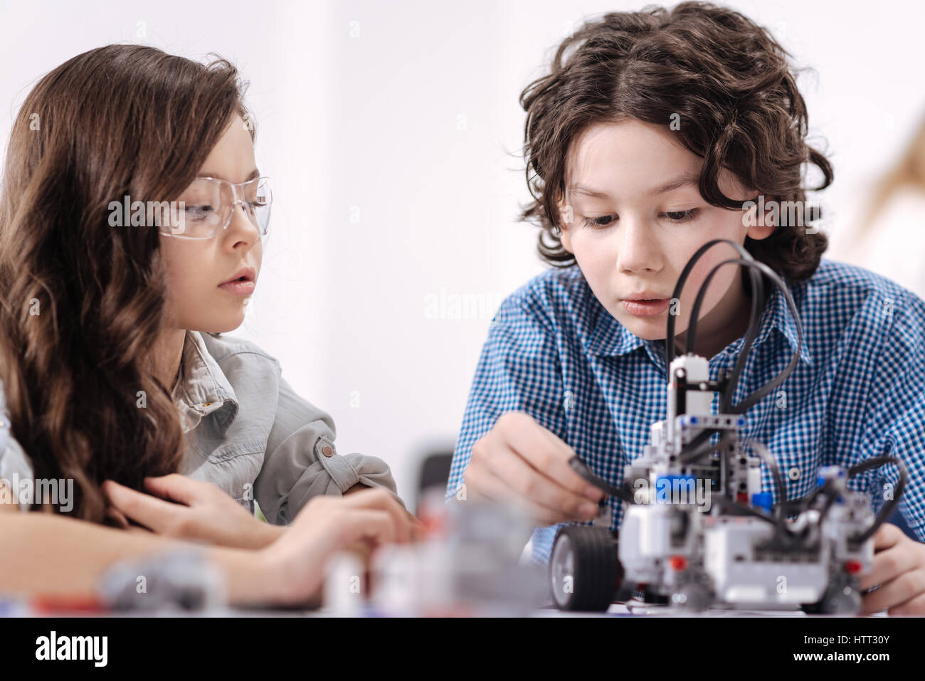 Ingenious kids creating robot at school Stock Photo - Alamy