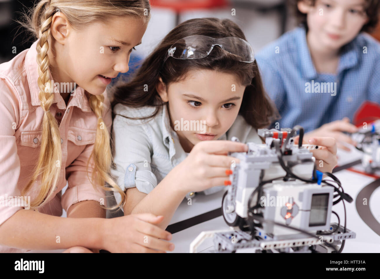 Involved children discussing project at school Stock Photo - Alamy