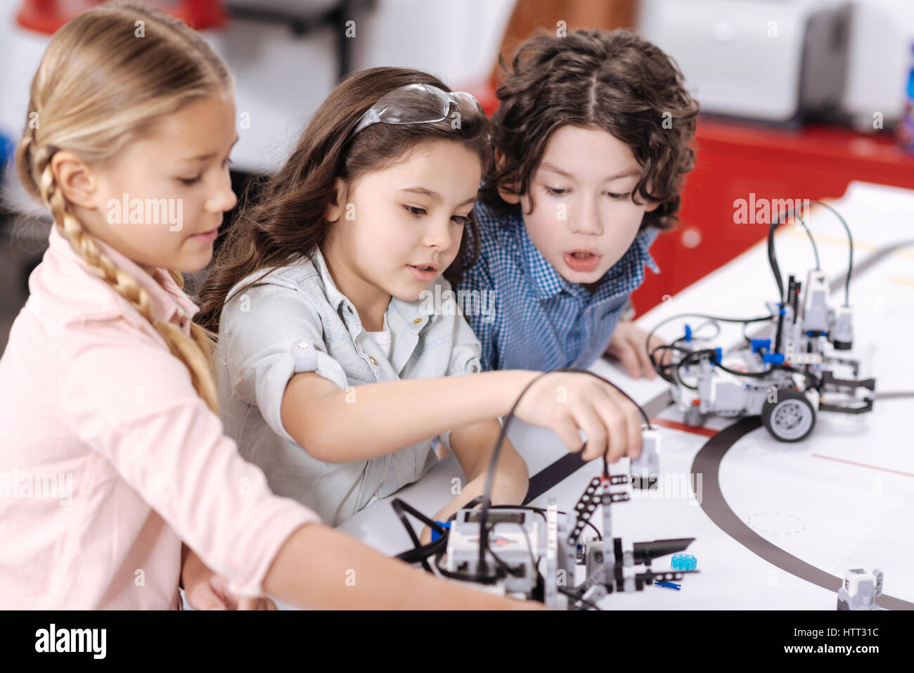 Lively children discussing project at school Stock Photo - Alamy