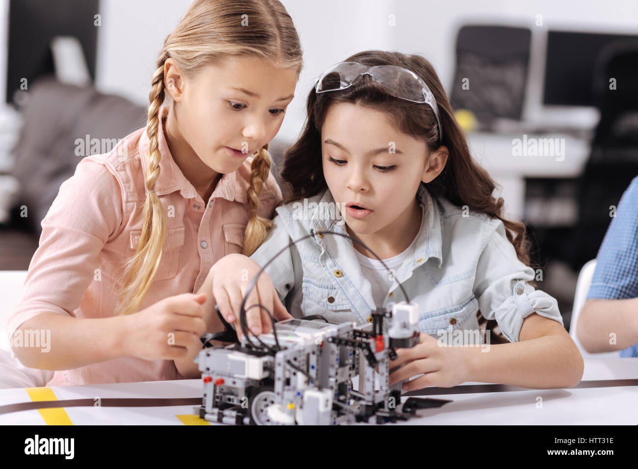 Surprised young scientists having tech class at school Stock Photo - Alamy