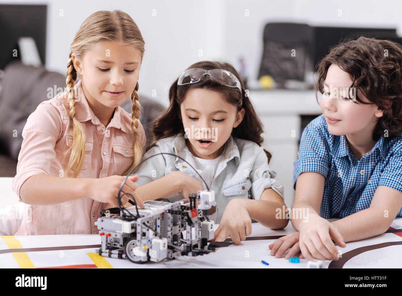 Delighted little scientists enjoying tech class at school Stock Photo ...