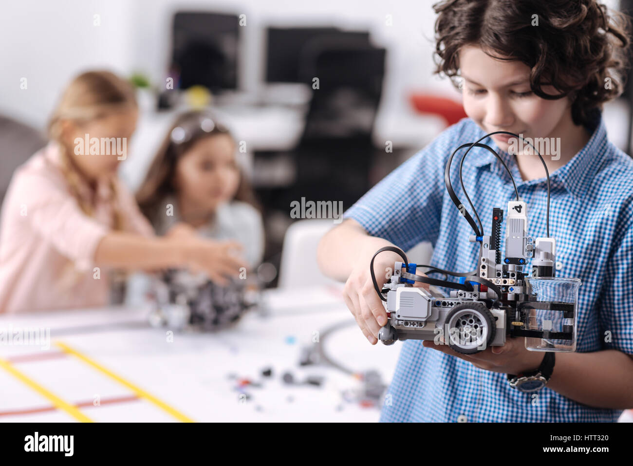 Skilled young pupil demonstrating robot at school Stock Photo - Alamy