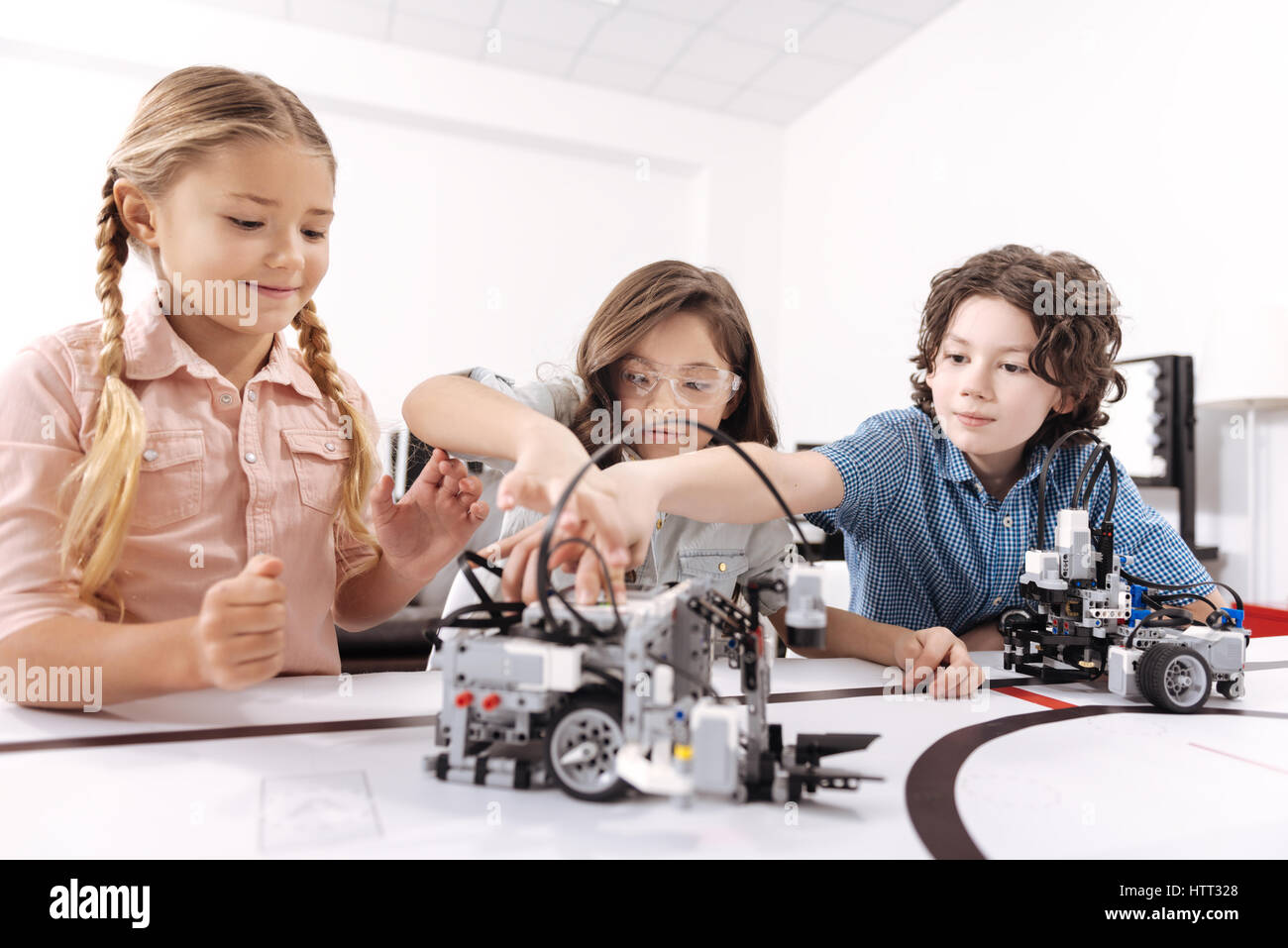 Optimistic children working on the tech project at school Stock Photo ...