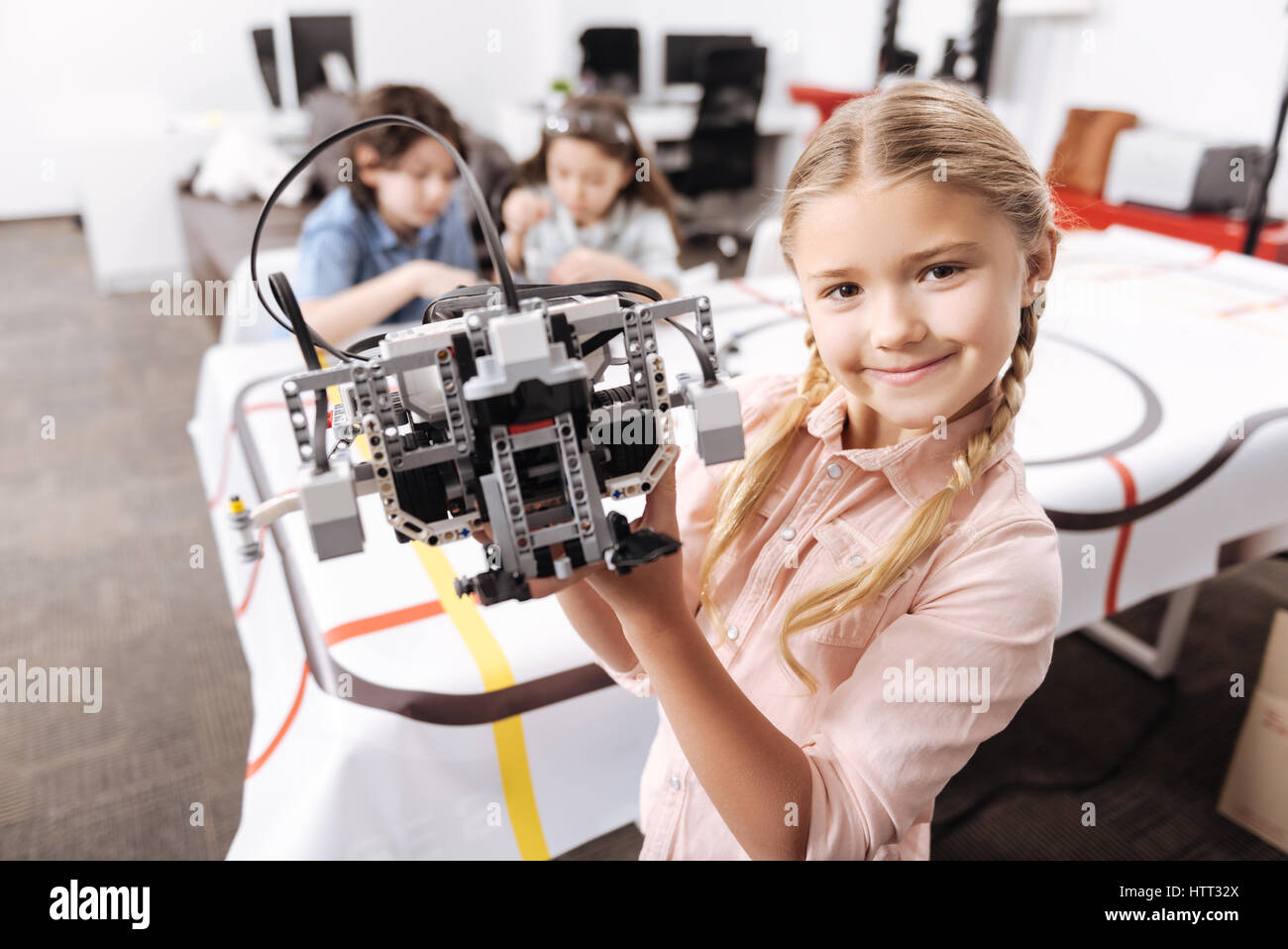 Cute little girl demonstrating robot at school Stock Photo - Alamy
