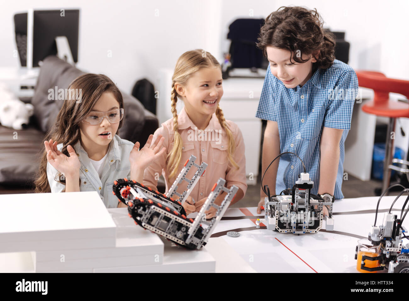Amazed pupils testing electronic robots at school Stock Photo - Alamy