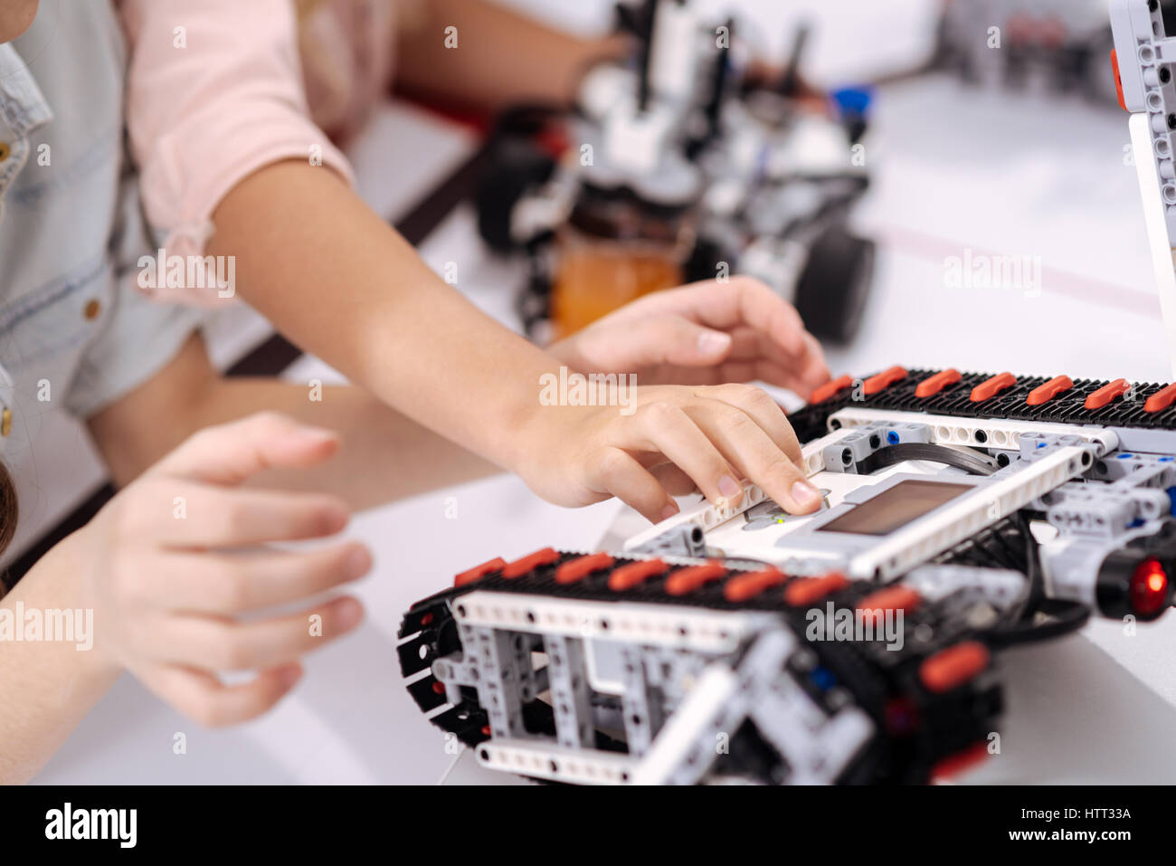 Skilled schoolchildren testing electronic robots at school Stock Photo ...