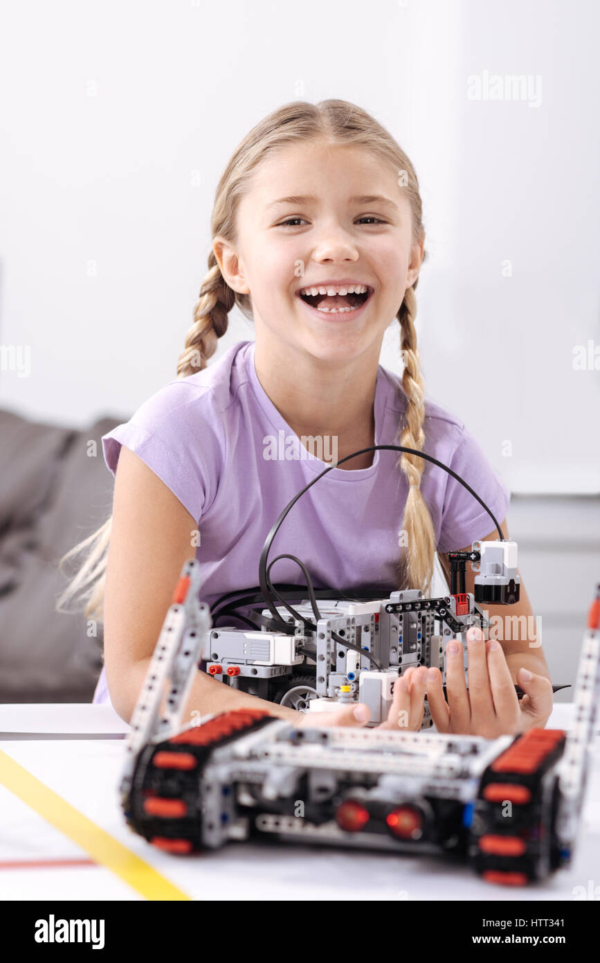 Smiling girl creating electronic robot at school Stock Photo - Alamy