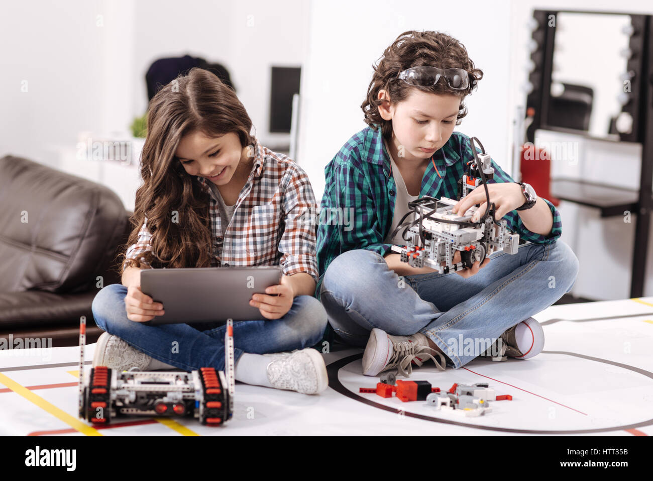 Cheerful kids using modern gadgets and devices at home Stock Photo - Alamy