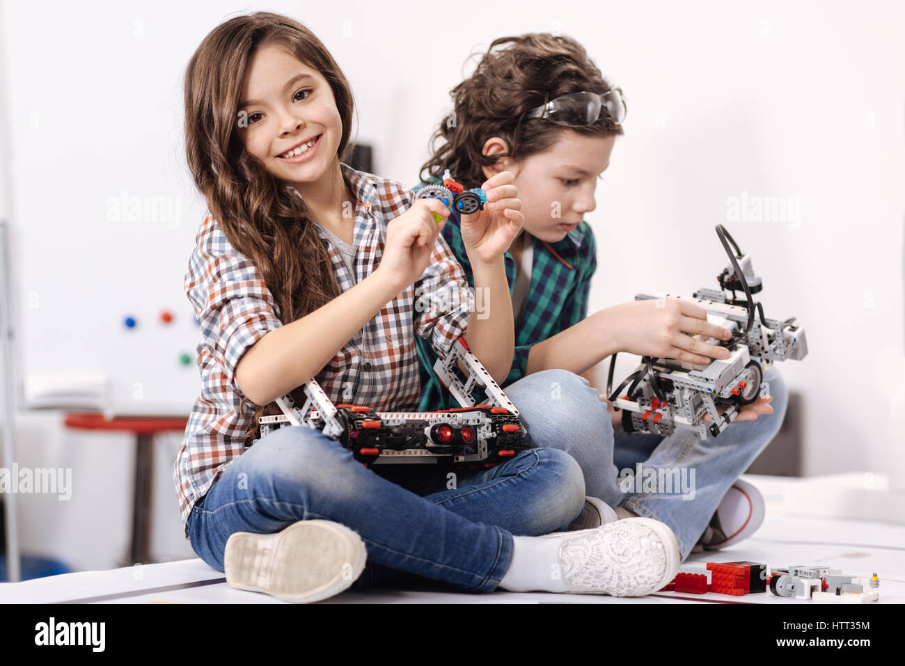 Merry little children using gadgets and devices at home Stock Photo - Alamy