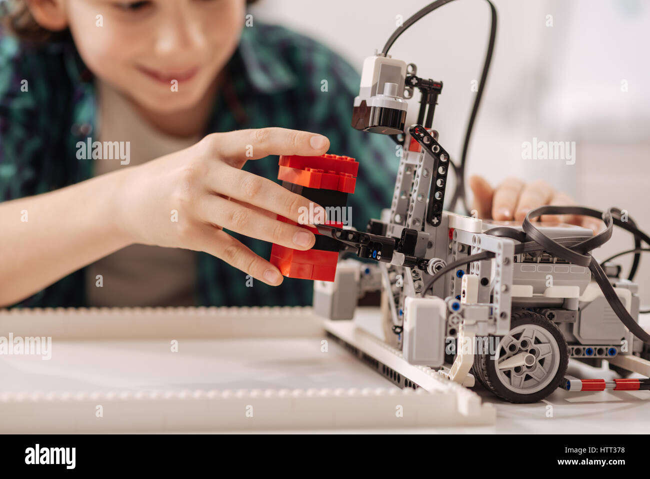 Inventive teen kid constructing robot in the studio Stock Photo - Alamy