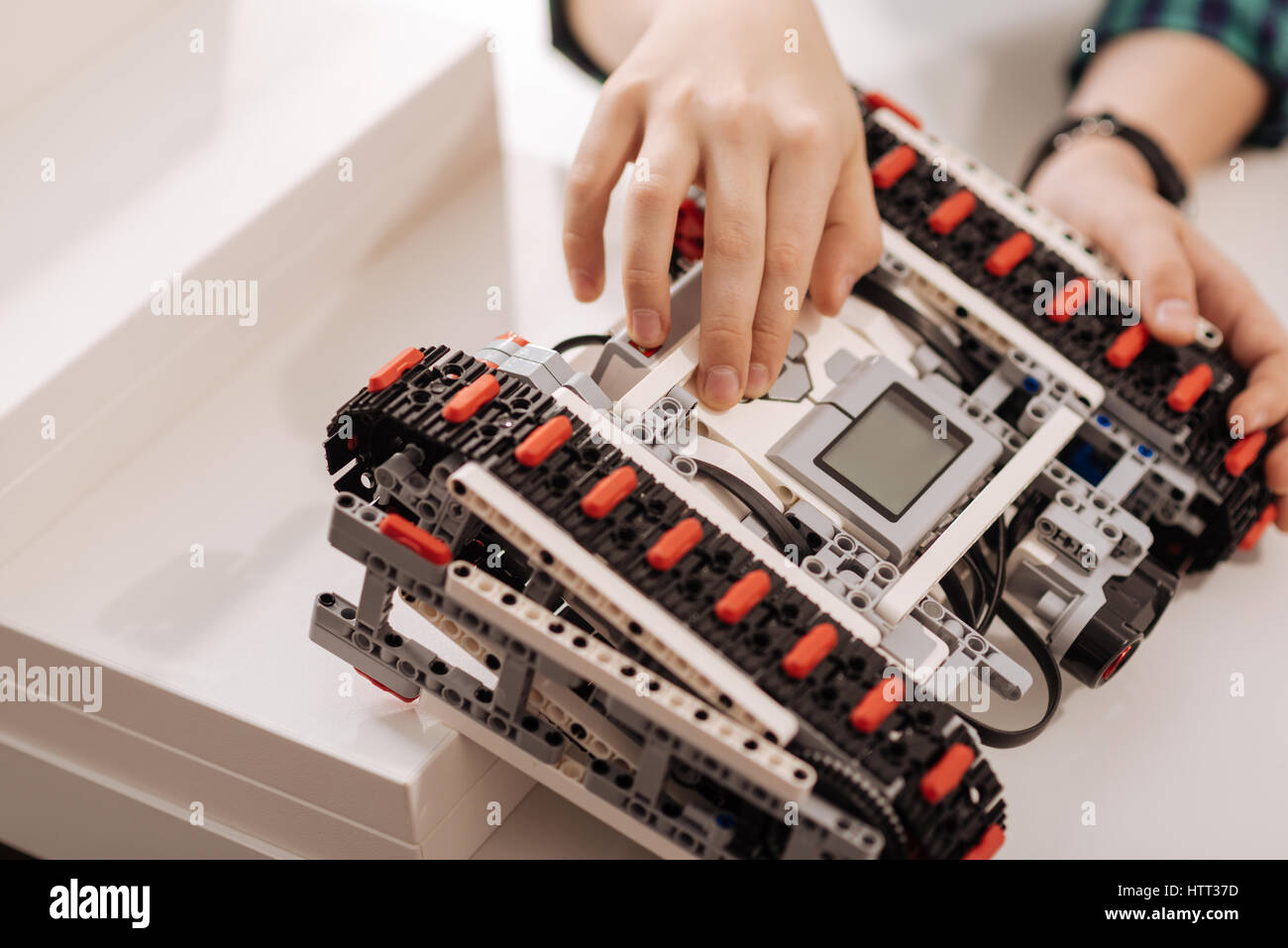 Clever child programming electronic robot in the studio Stock Photo - Alamy
