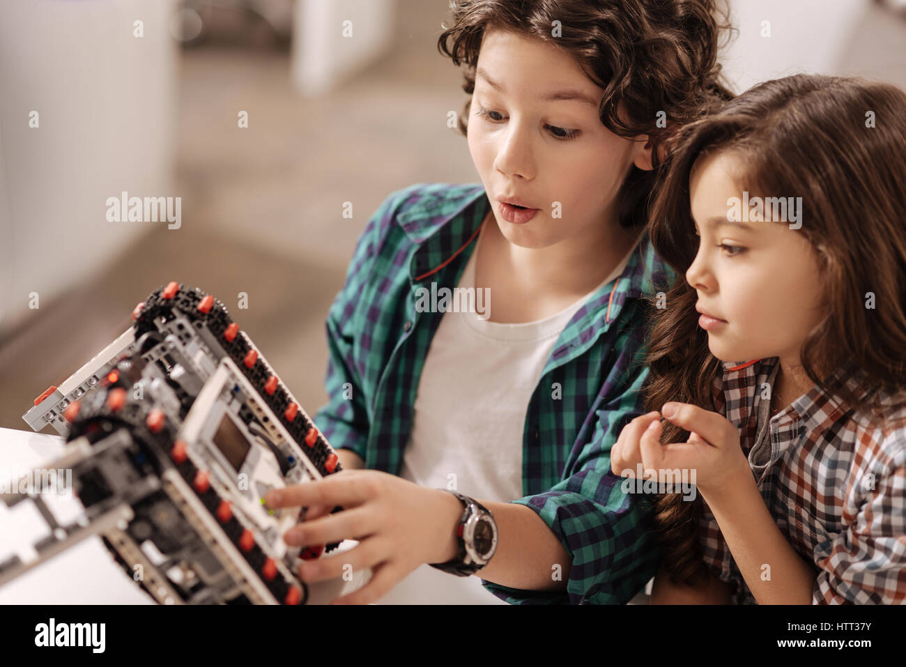 Astonished children programming robot in the science studio Stock Photo ...