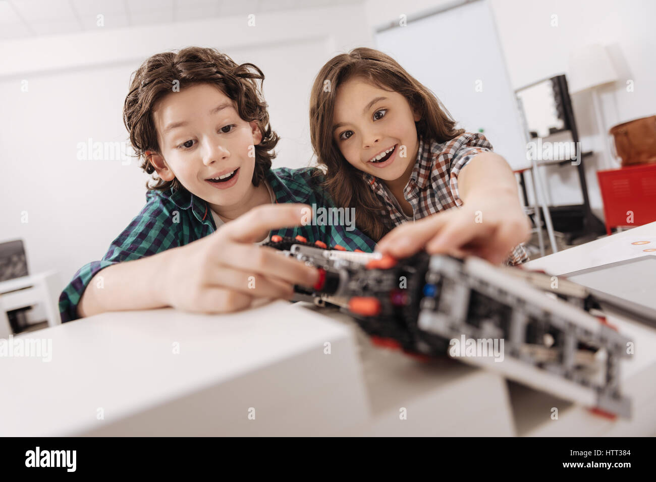 Delighted children programming electronic robot in the studio Stock ...