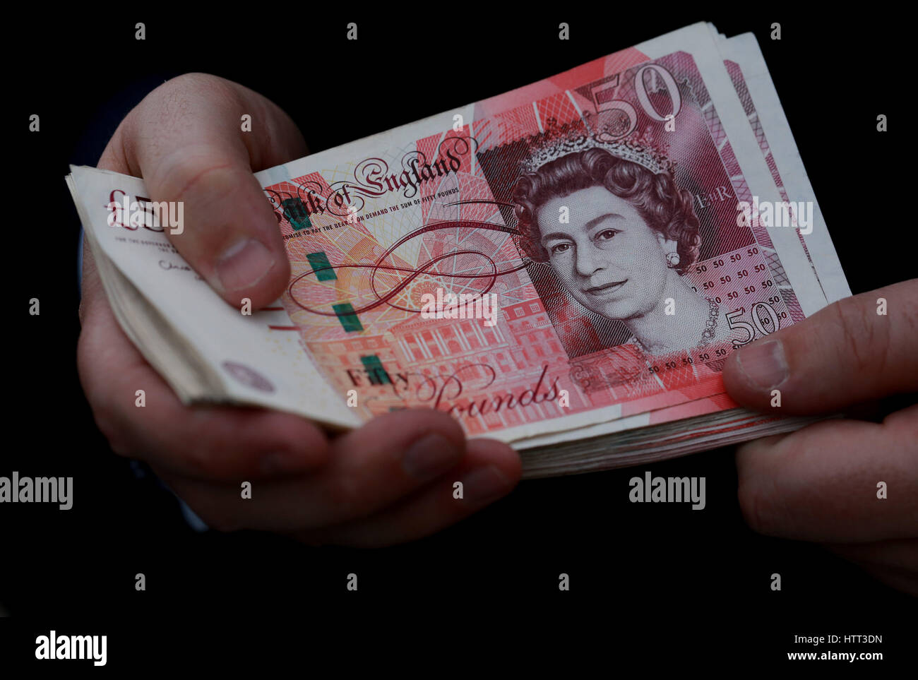 A bookmaker prepares his cash float before racing during Champion Day ...
