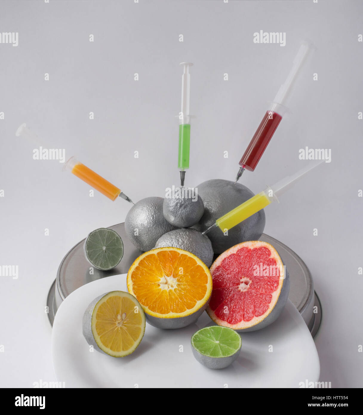 Injection into citrus fruits - orange, grapefruit, lemon, lime. Concept ...