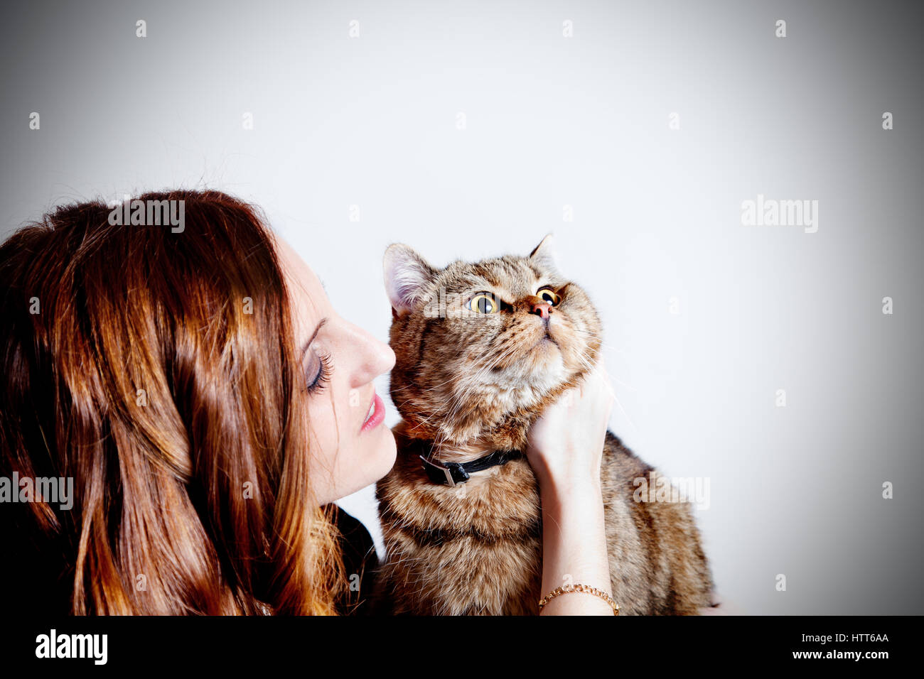 Beautiful girl with her cat on white background. People and pets ...