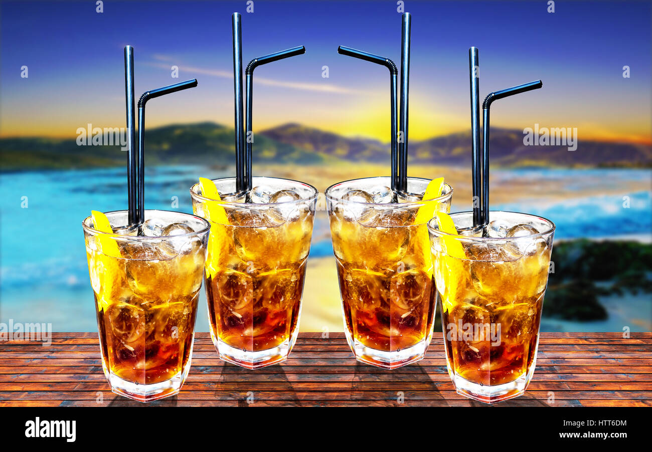 Four cuba libre exotic tasty cocktails background beach and turquoise ...