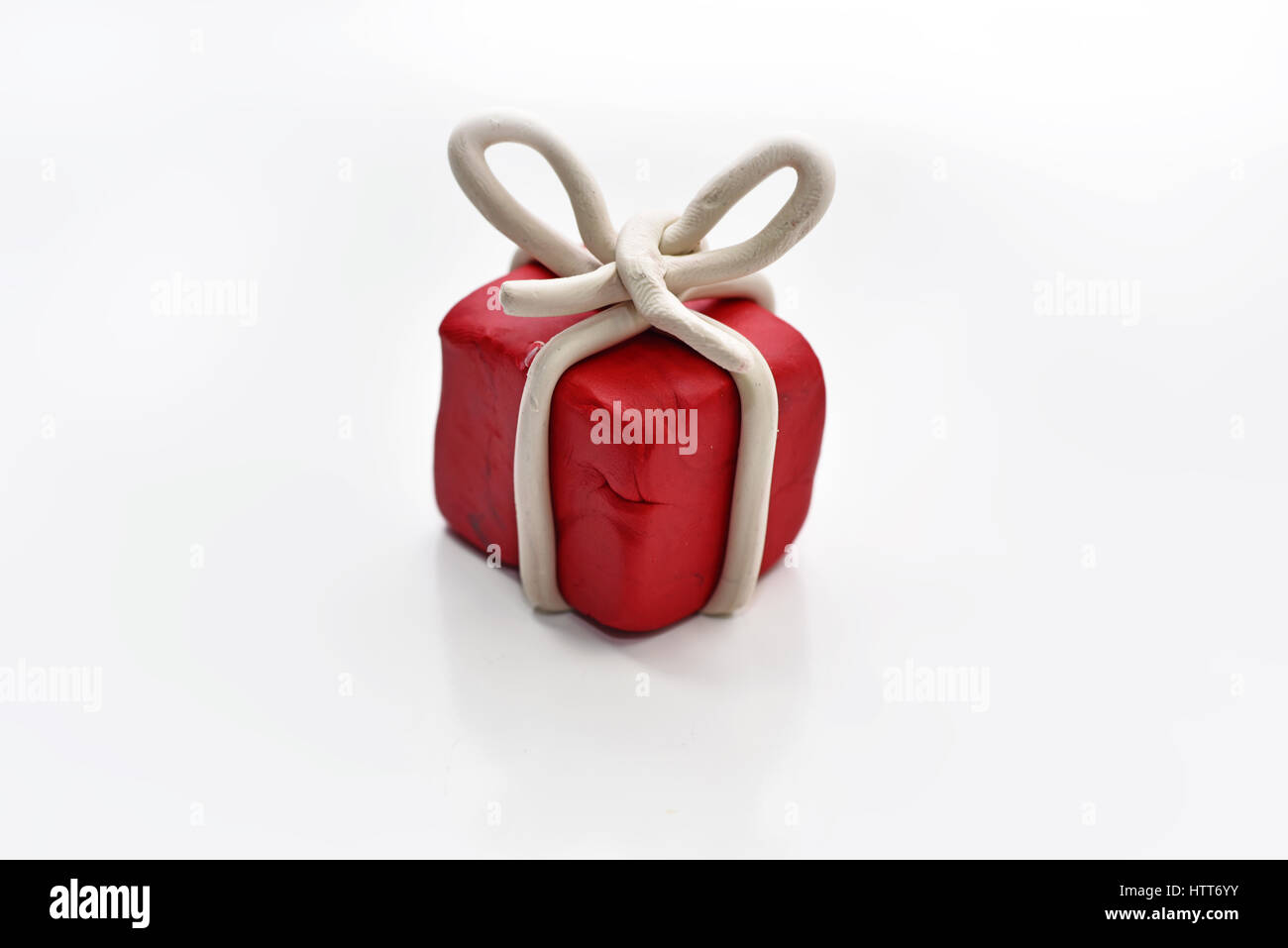 Red present made from plasticine. Isolated on white background Stock ...