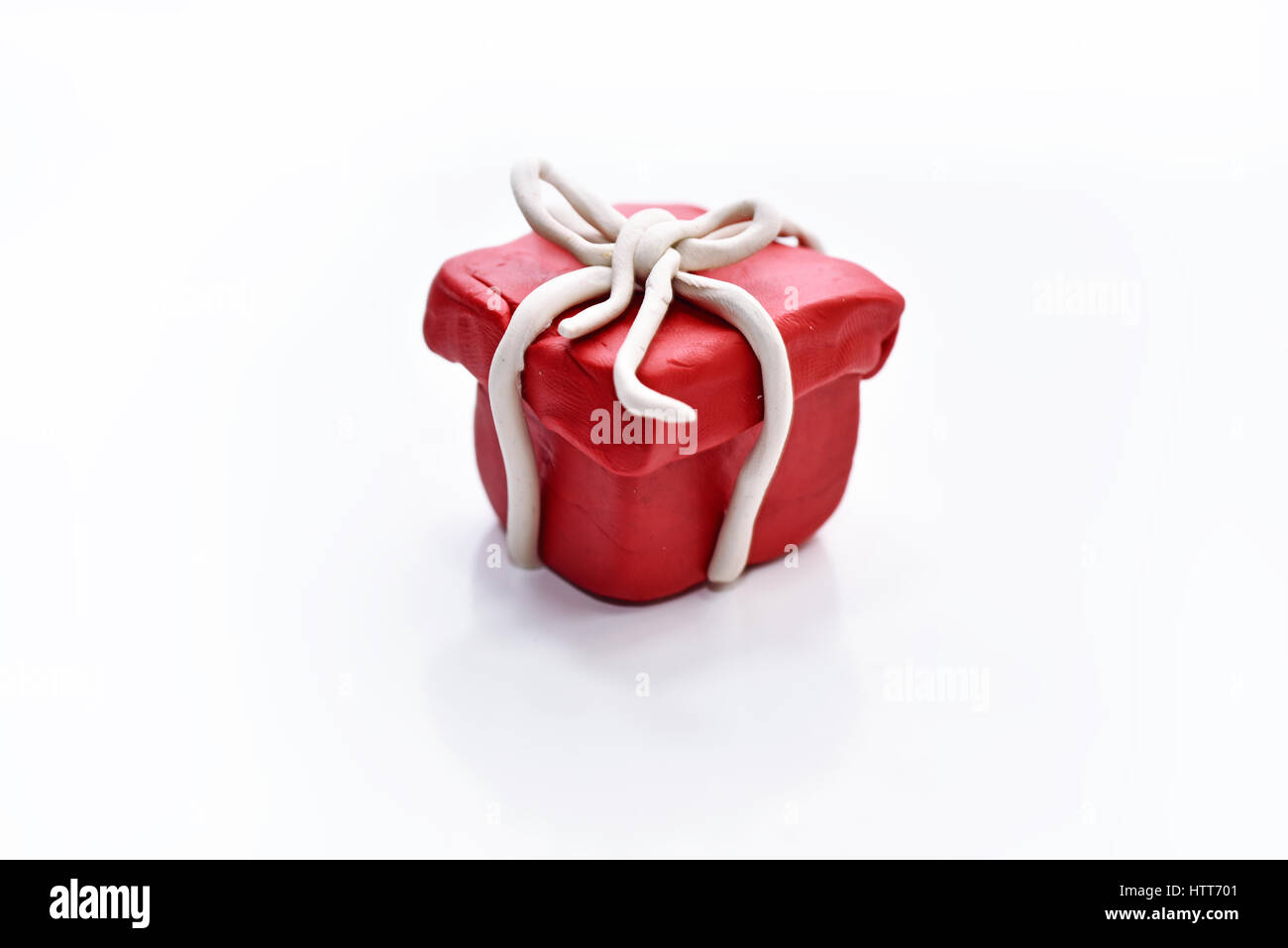 Red present made from plasticine. Isolated on white background Stock ...