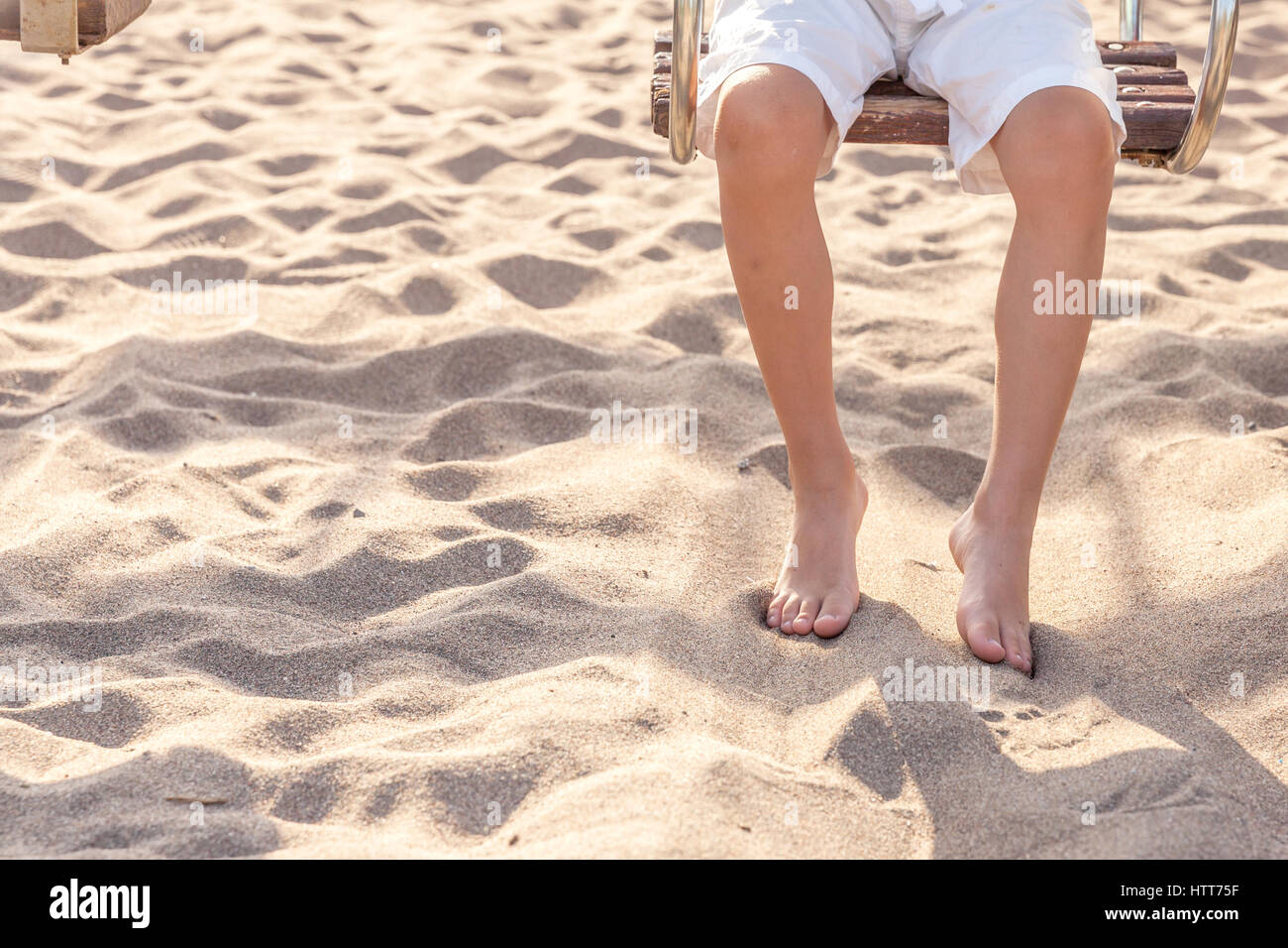 Child swinging legs hi-res stock photography and images - Alamy