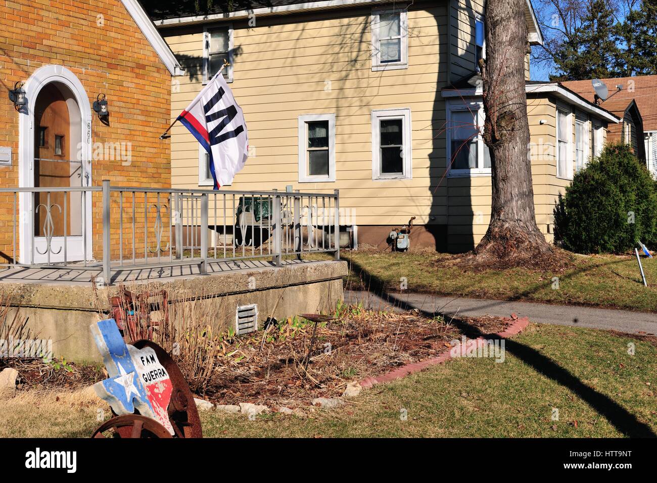 Homes on a block in Elgin, Illinois. The house at left flies a W flag ...